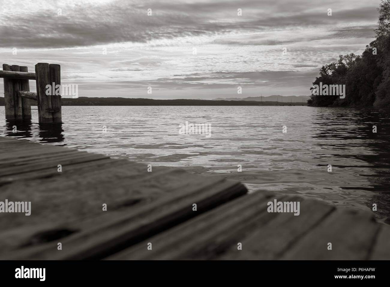 Footbridge at a lake with clodus on the sky at the sunset Stock Photo ...