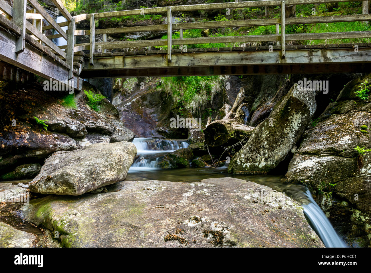 Bridge with a waterfall in the green nature in the bavarian forest with ...