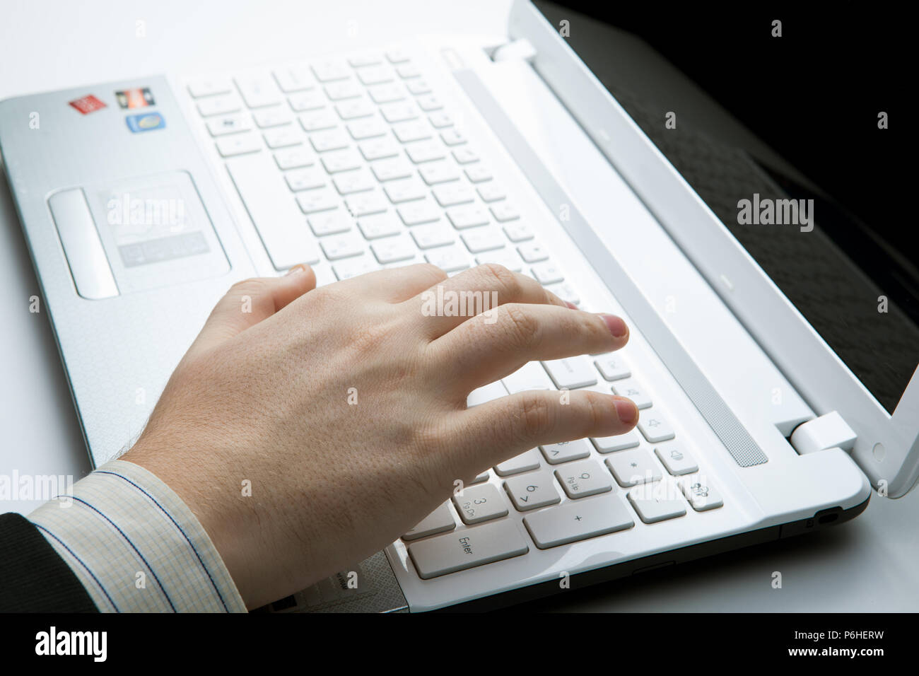 human hand on the notebook keyboard close-up Stock Photo - Alamy