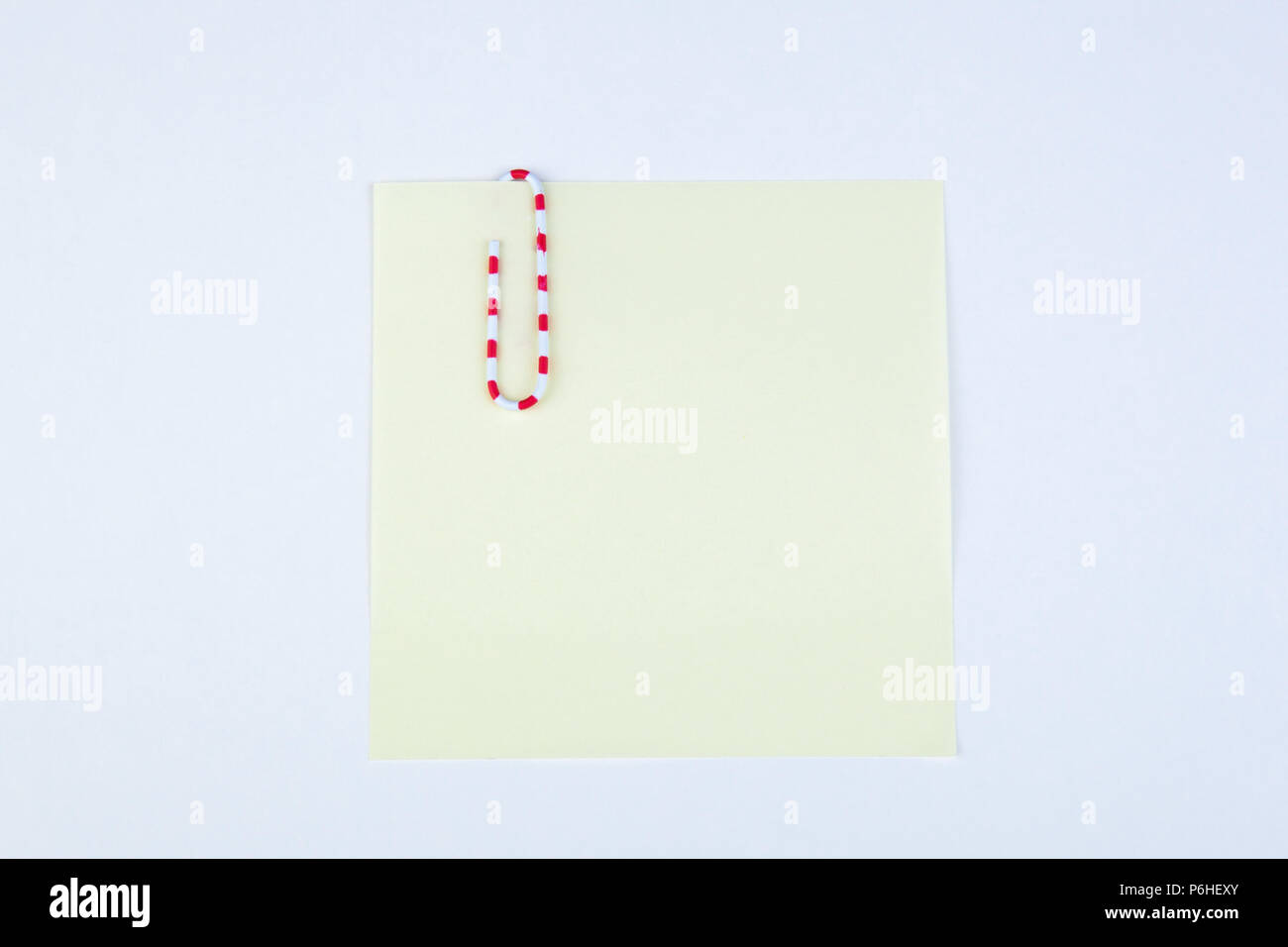 sheet of pad yellow paper witn paper clip close-up Stock Photo - Alamy