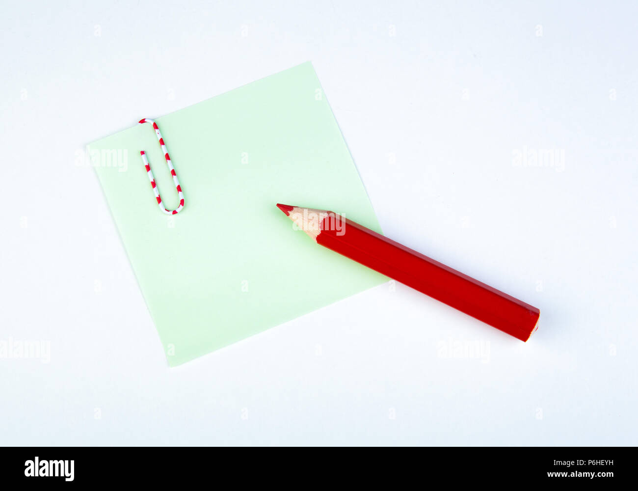 sheet of pad green paper witn red pencil close-up Stock Photo - Alamy