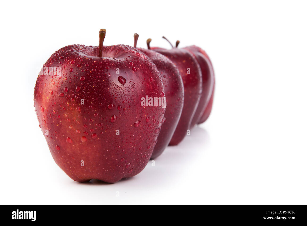 maroon apples lined up in a row closeup on a white background Stock ...