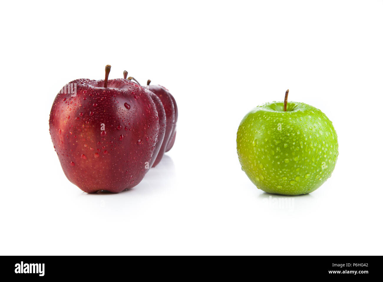 maroon apples lined up in a row and green apple closeup on a white ...