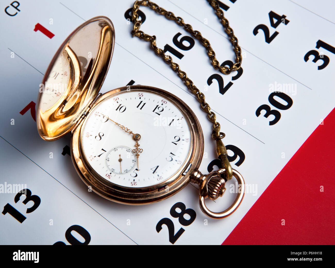 Gold pocket watch with wall calendar close-up Stock Photo - Alamy