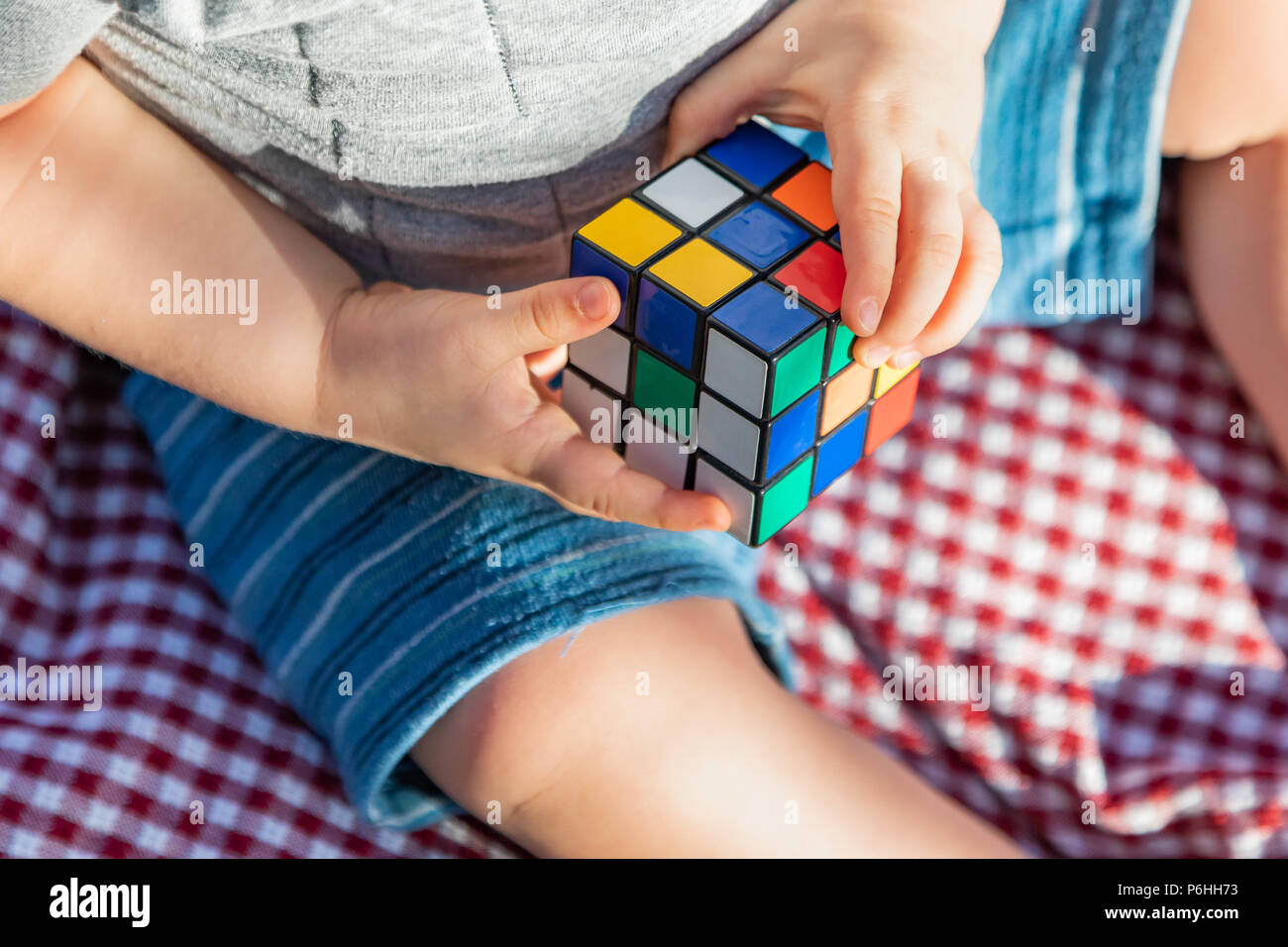 Baby Boy Sitting on Picnic Blanket Playing With Cube Puzzle Stock Photo ...