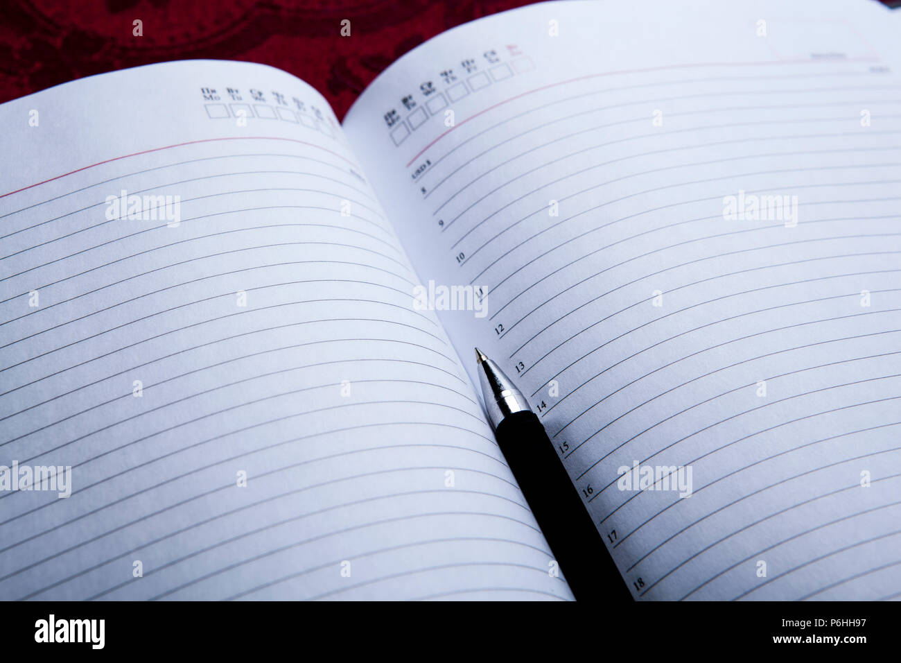 open diary with black pen close-up Stock Photo - Alamy
