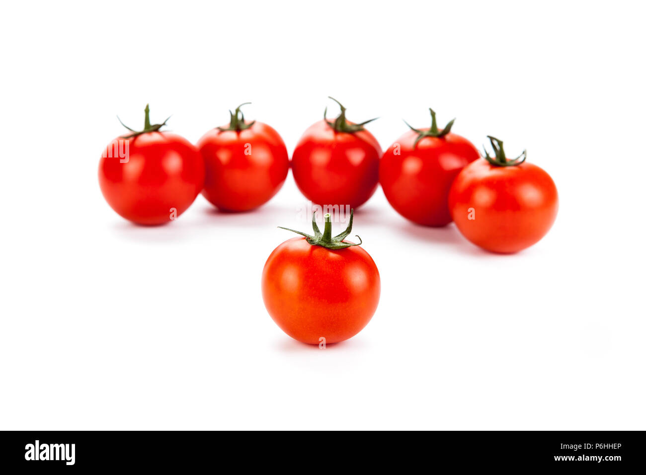 six red tomatoes on a white background Stock Photo - Alamy