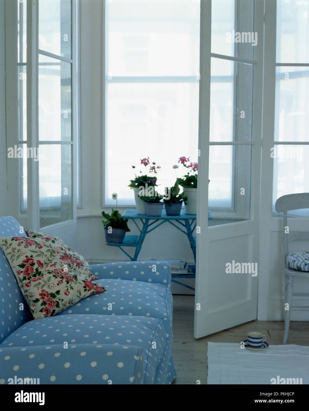 White French windows open in coastal living room with pale blue spotted ...
