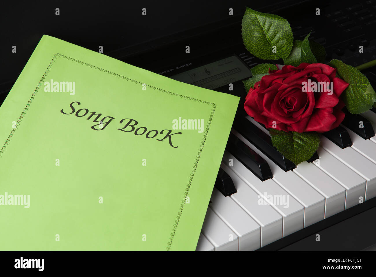 Piano keys, song book,and rose flower Stock Photo - Alamy