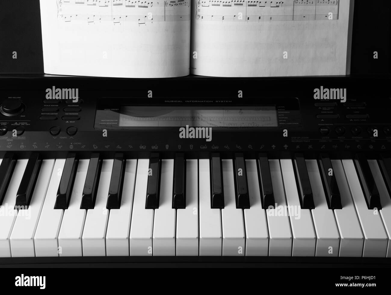 Piano keys and musical book Stock Photo - Alamy