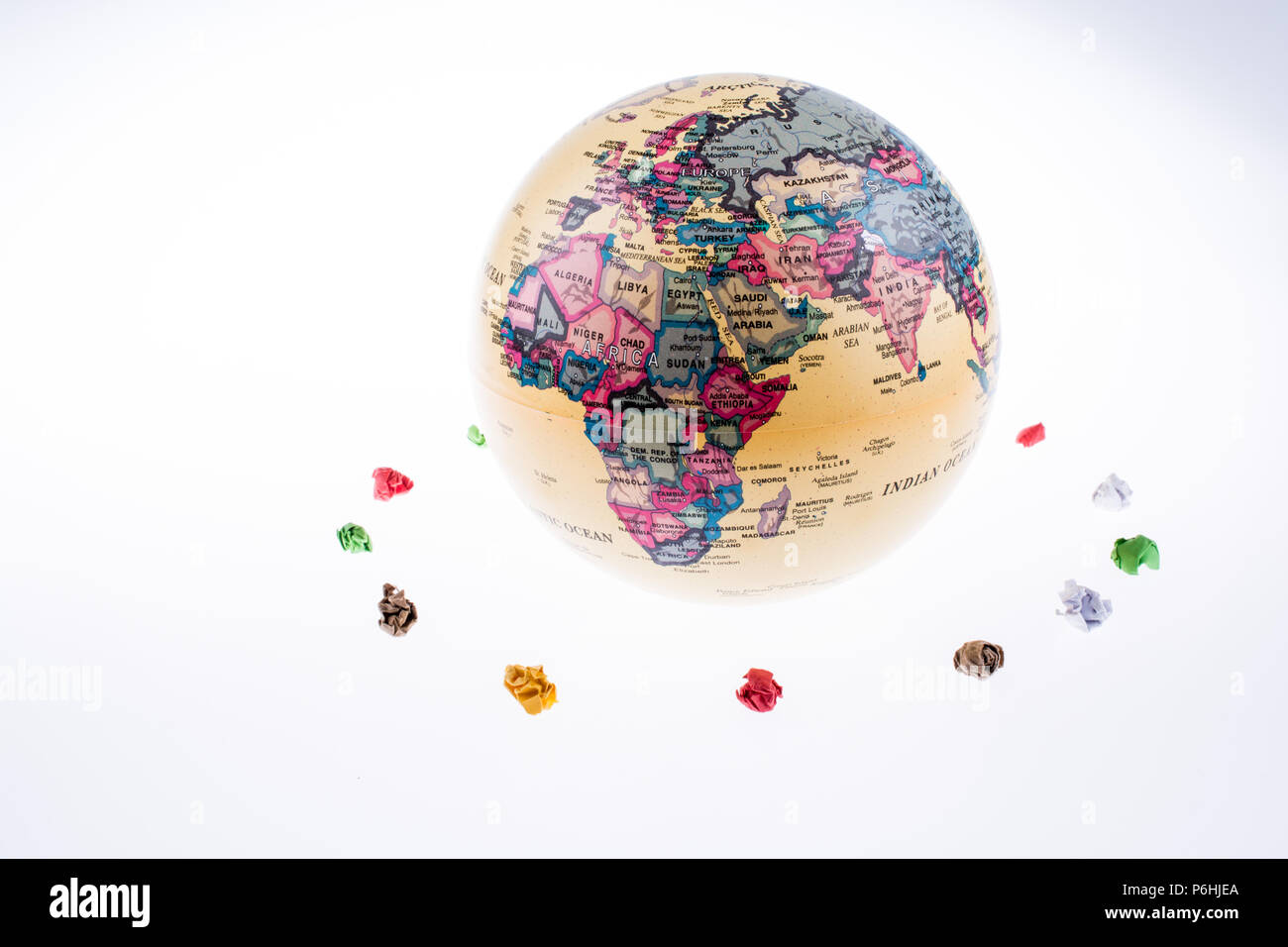 globe orbit and crumpled papers on a white background Stock Photo - Alamy
