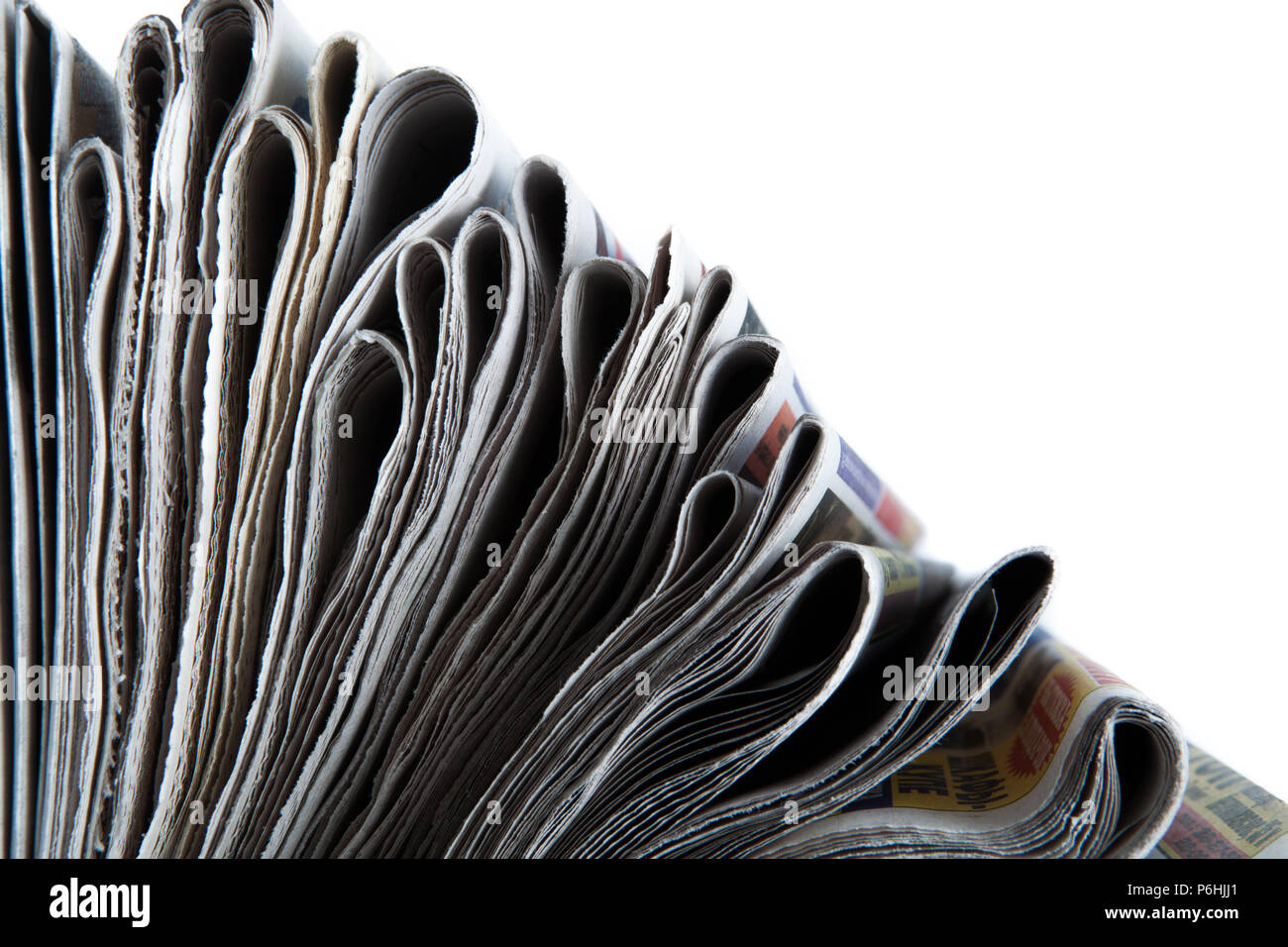 stack of newspapers close-up on white Stock Photo - Alamy