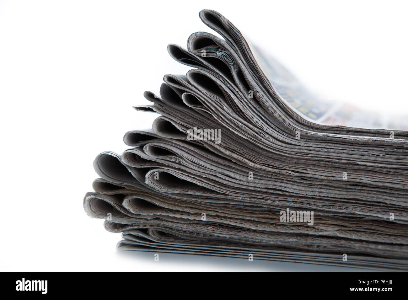 stack of newspapers close-up on white Stock Photo - Alamy