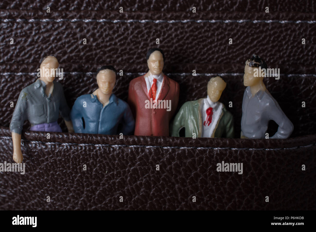 Tiny figurine of group of men miniature model in pockets Stock Photo ...