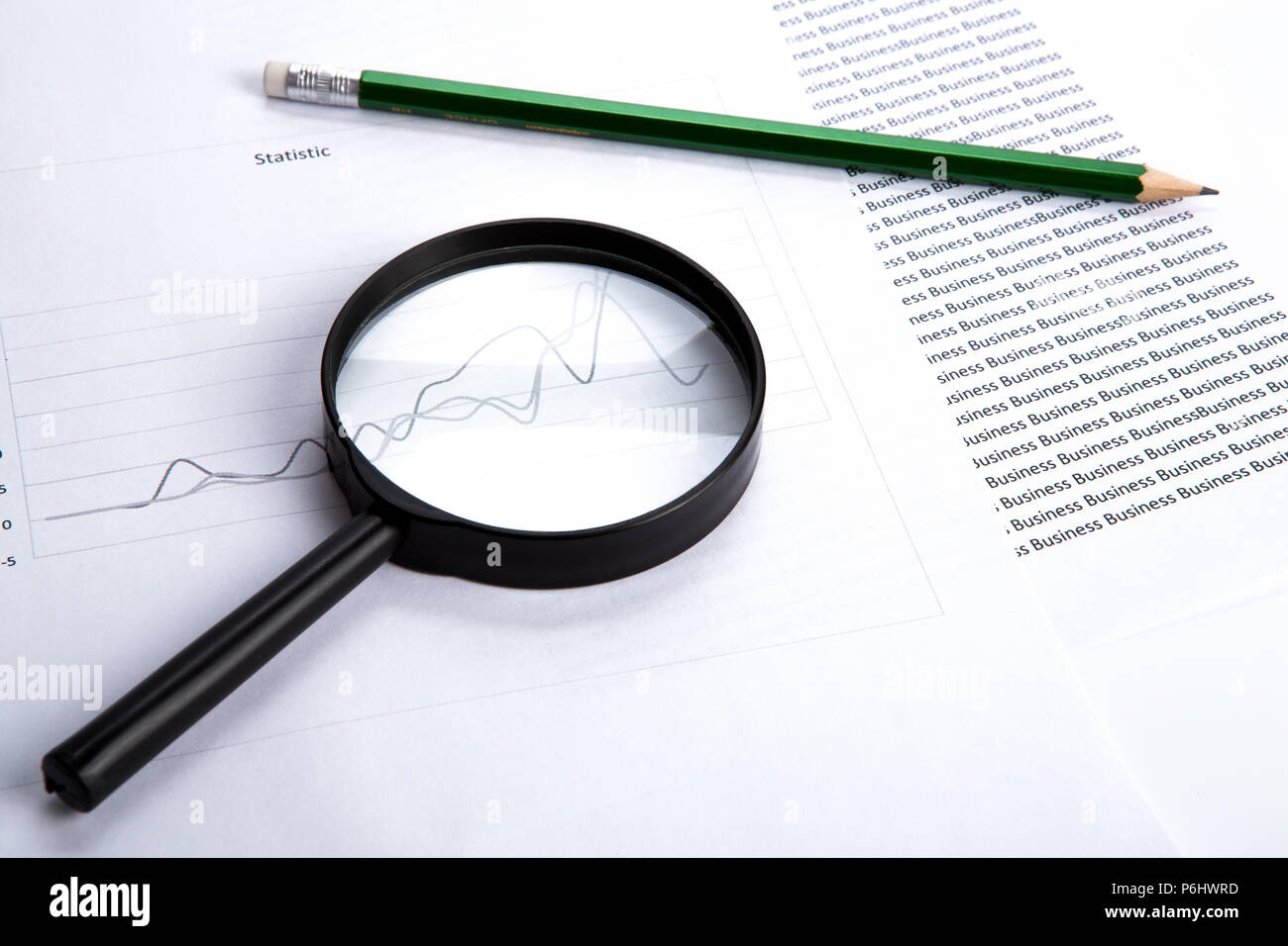 Magnifier, pencil and paper close-up Stock Photo - Alamy