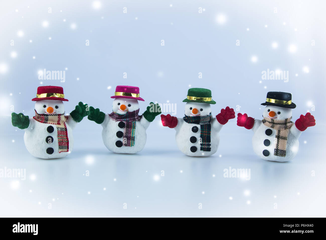 Gang of Snowman stand on white background. Snow flake is falling down ...