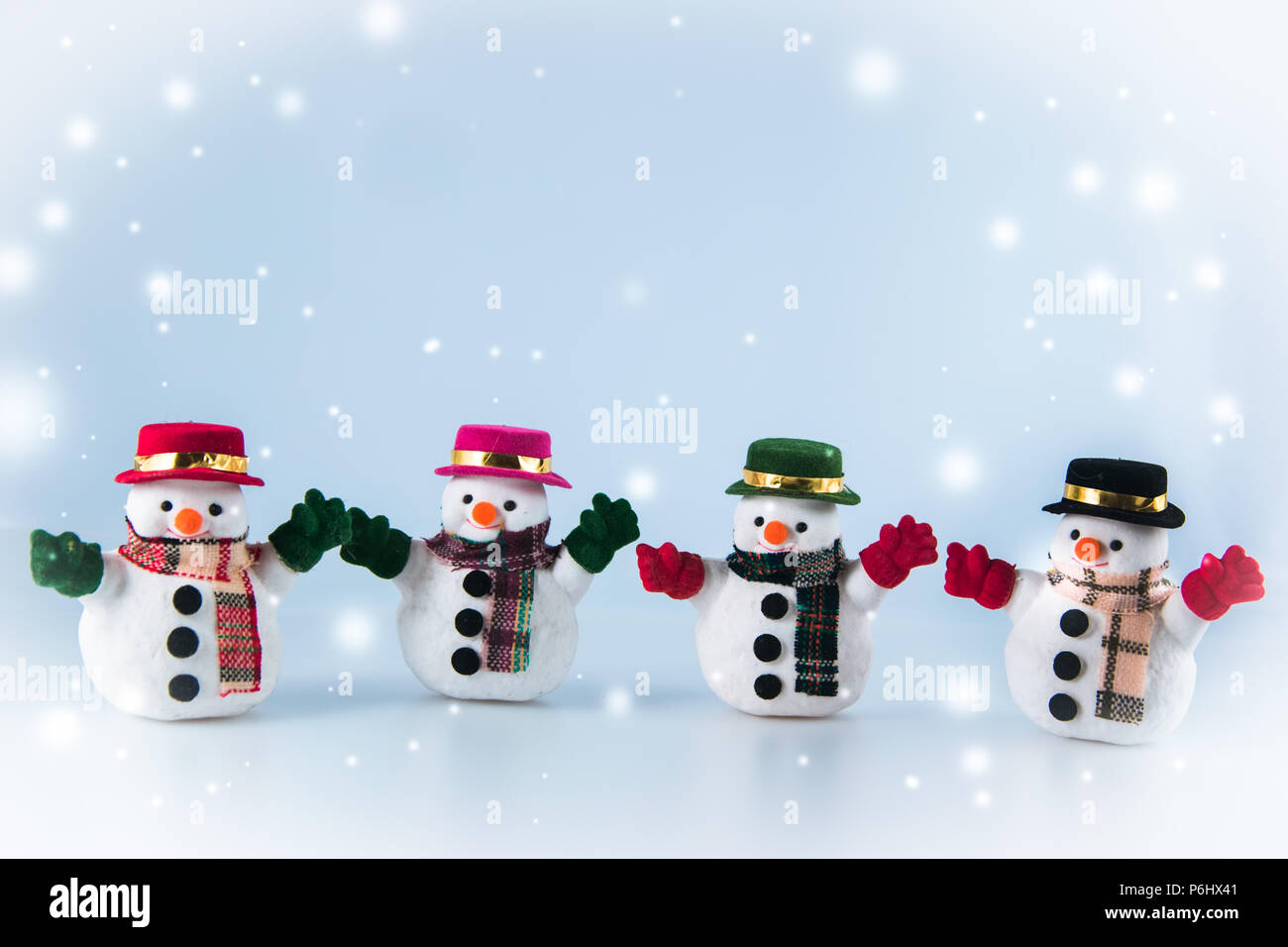 Gang of Snowman stand on white background. Snow flake is falling down ...