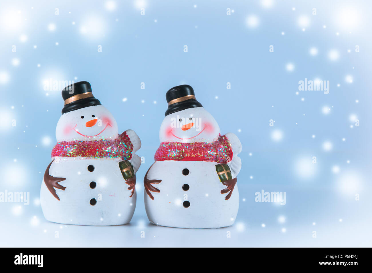 2 Snowman stand on white background. Snow flake is falling down Stock ...