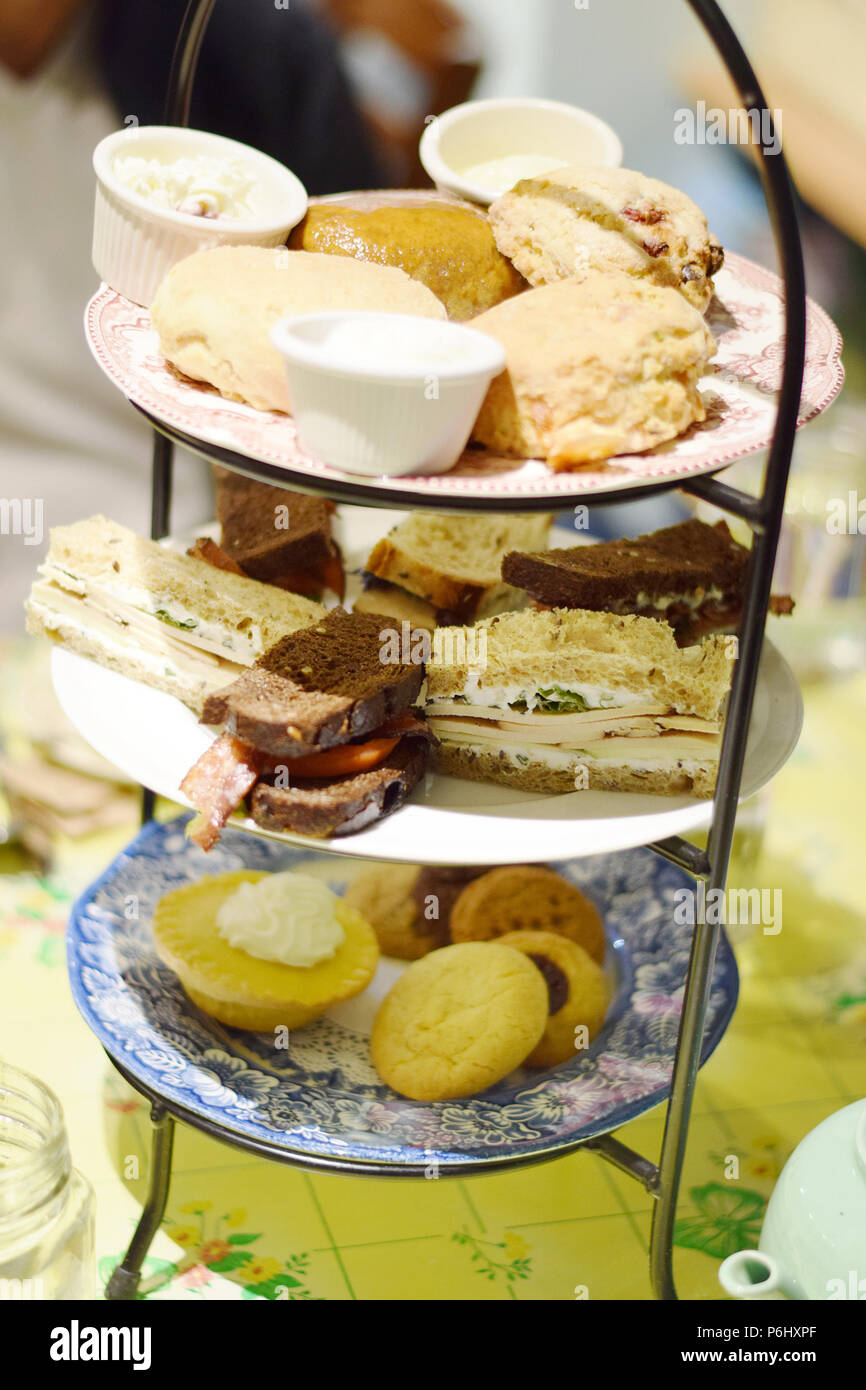 Sandwiches and scones on a tiered platter Stock Photo - Alamy