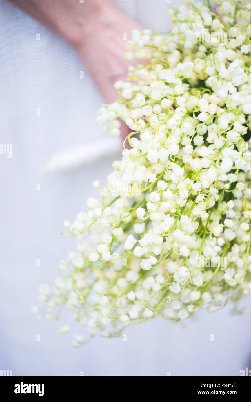 Beautiful may lilies in bride bunch on rustic background with copy ...