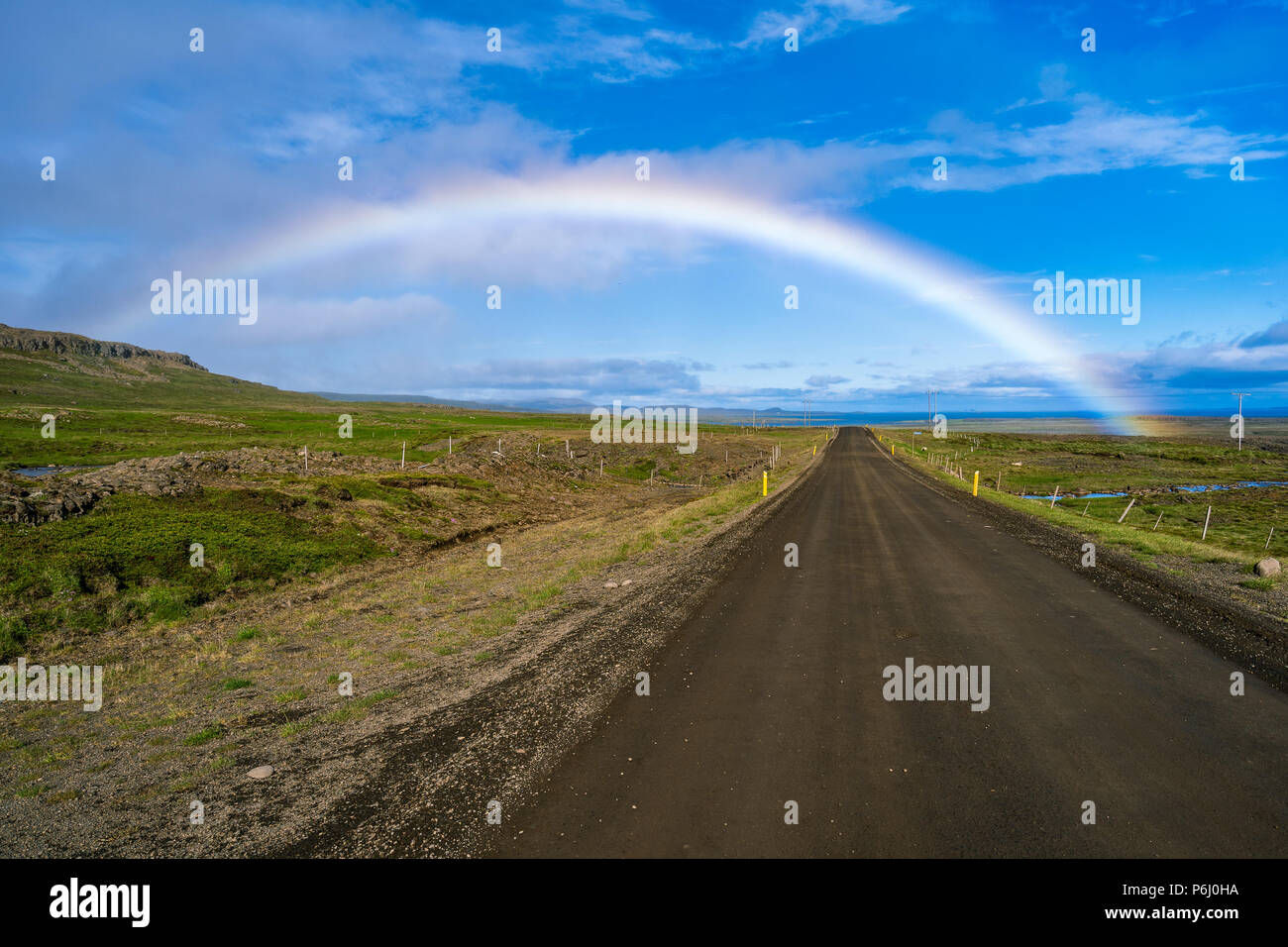 Rainbow over the road in Iceland Stock Photo - Alamy
