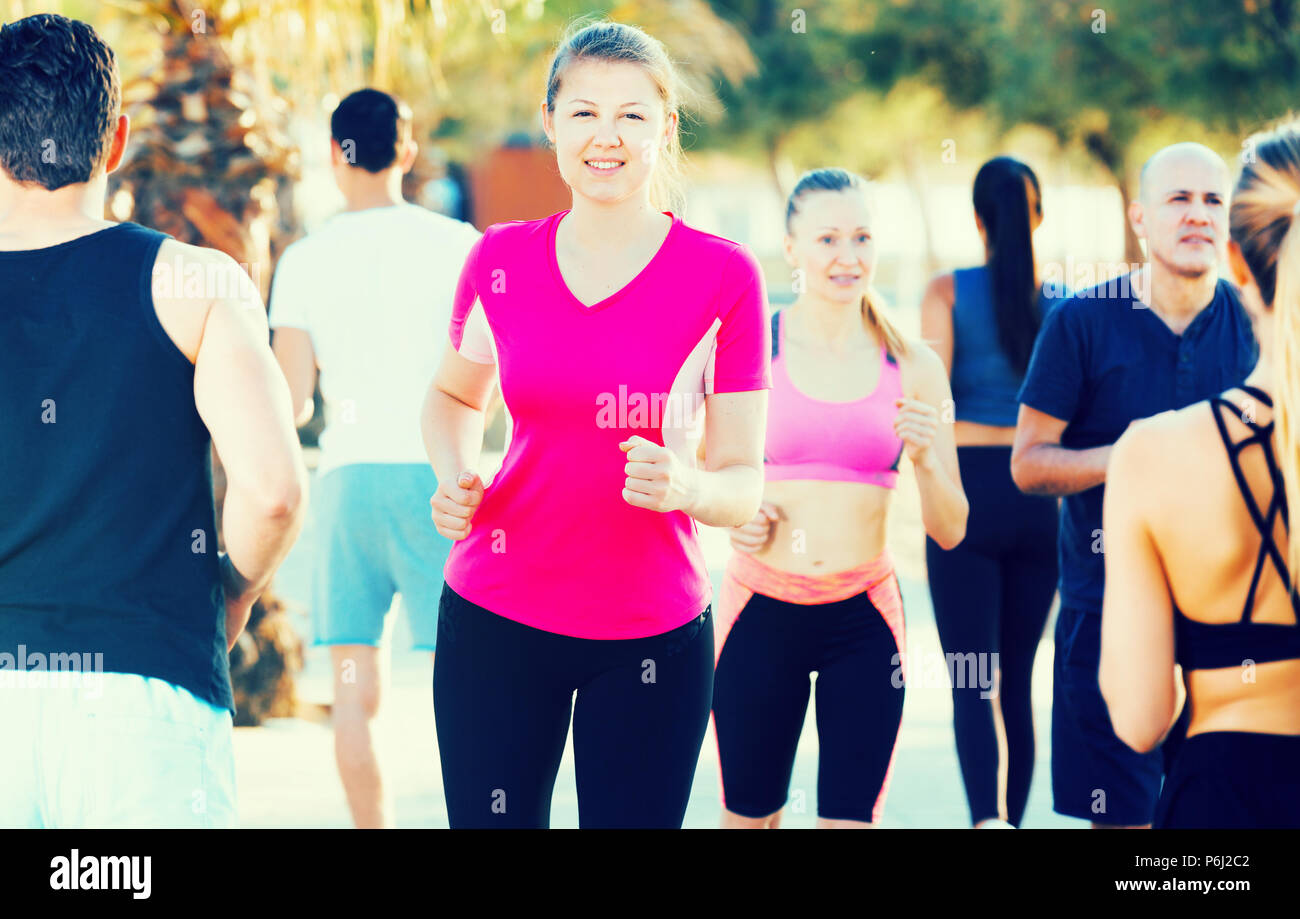 Active smiling people during running training in daytime Stock Photo ...