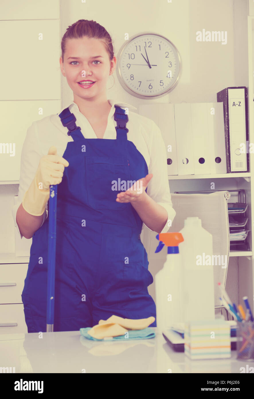 Cleaner female is talking while cleaning the cabinet in office Stock ...