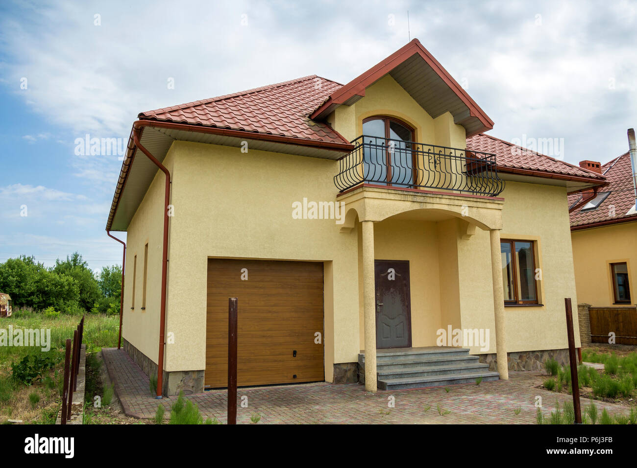 Two story yellow house porch hi-res stock photography and images - Alamy
