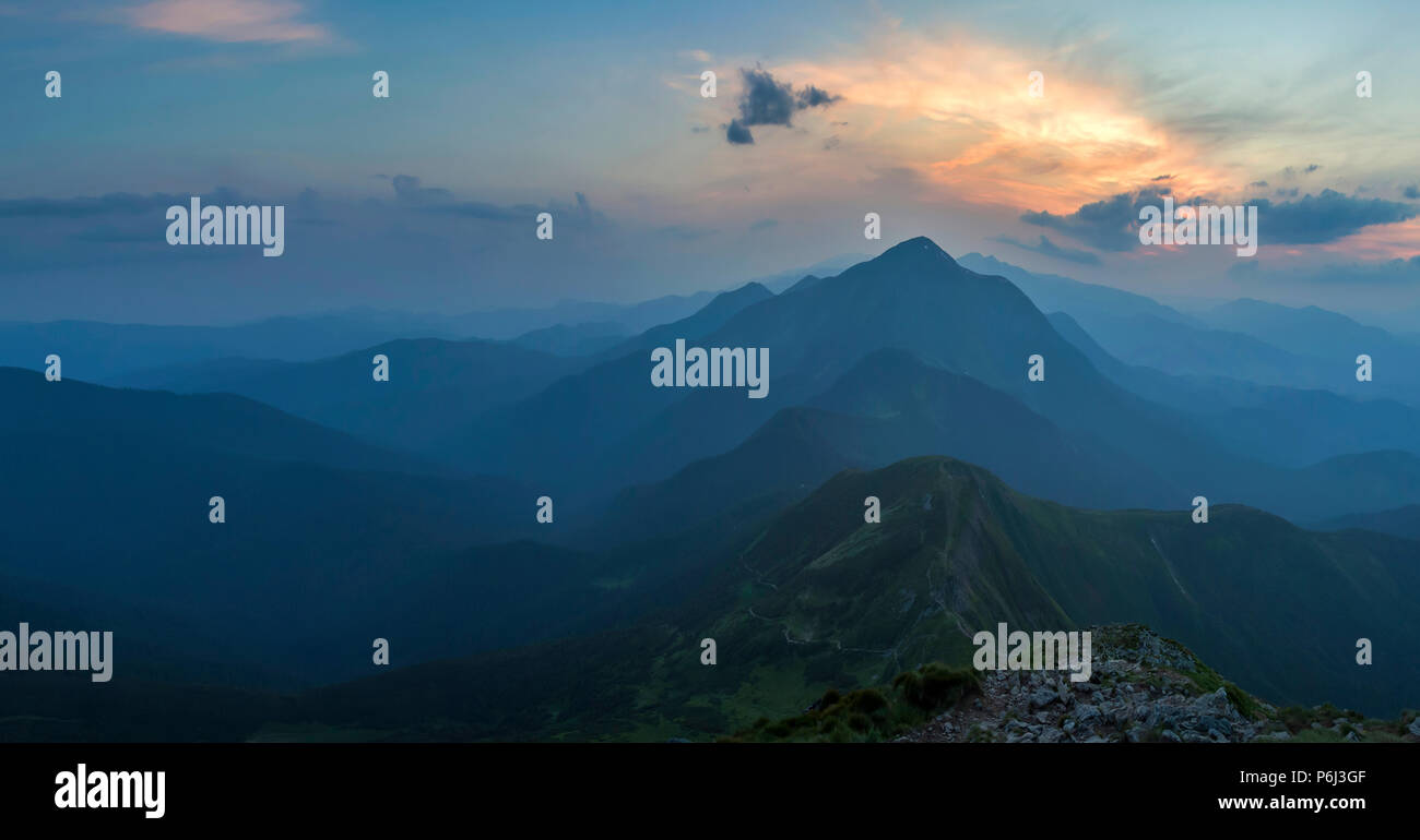 Fantastic sunrise or sunset over green mountain ridge covered with ...