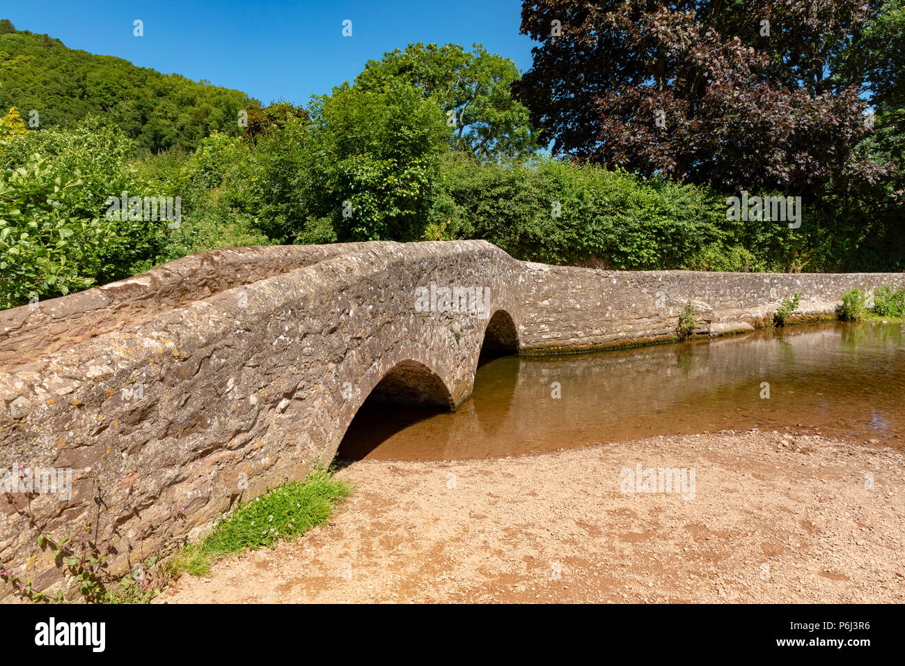 Dunster Somerset England June 27, 2018 The Gallox bridge across the ...