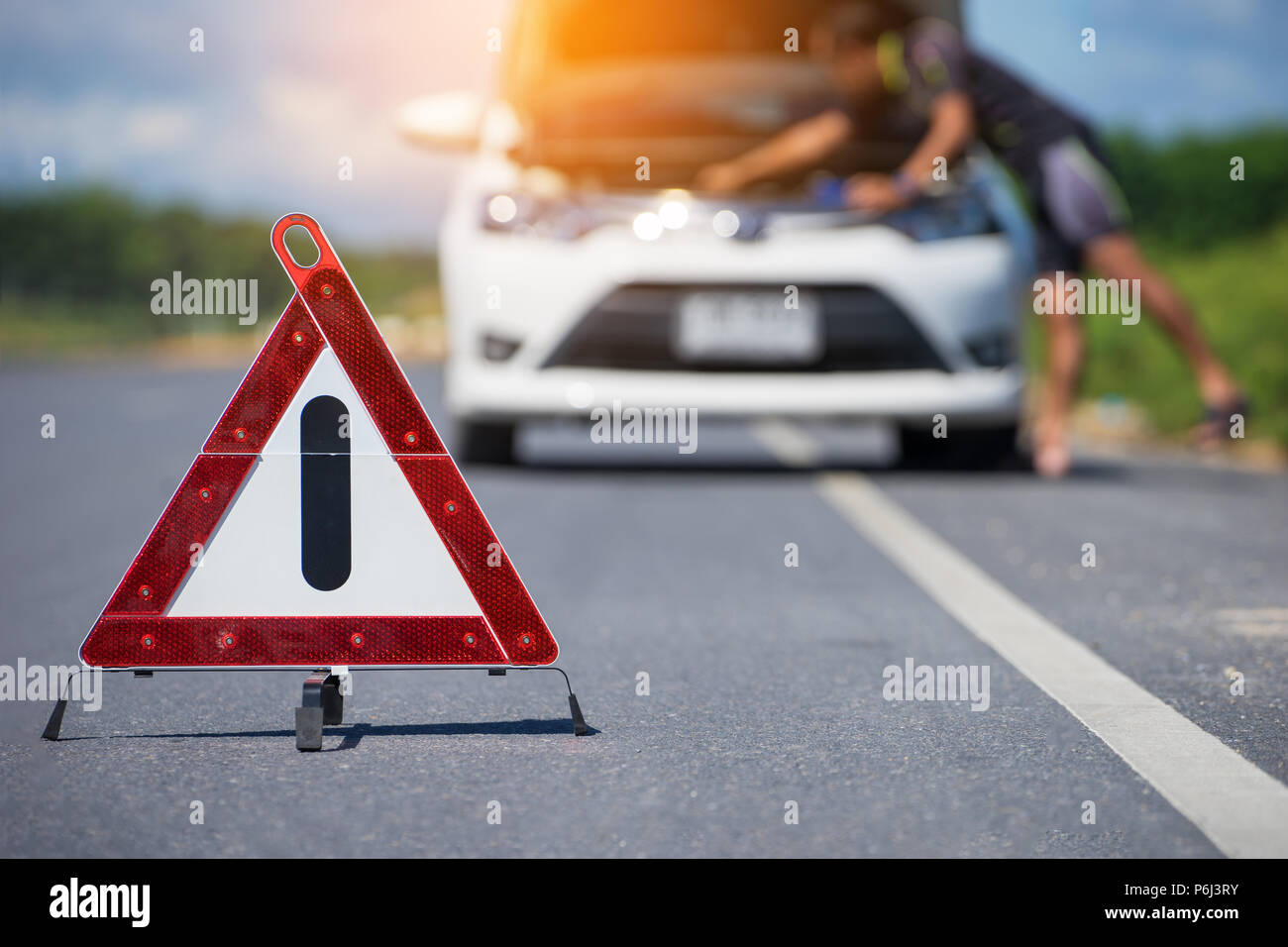 Red emergency stop sign and white car after accident on the road Stock ...