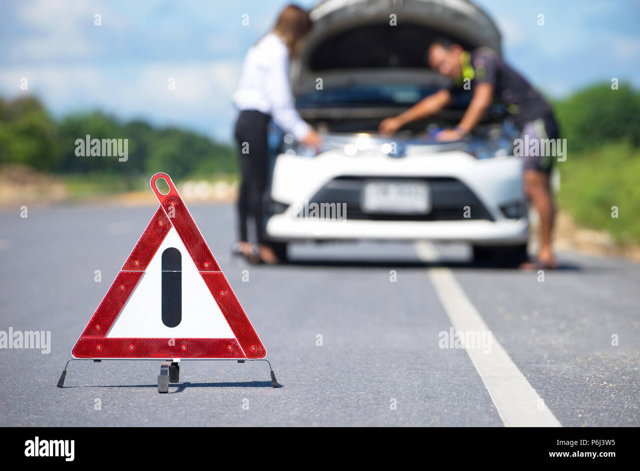 Red emergency stop sign and white car after accident on the road Stock ...