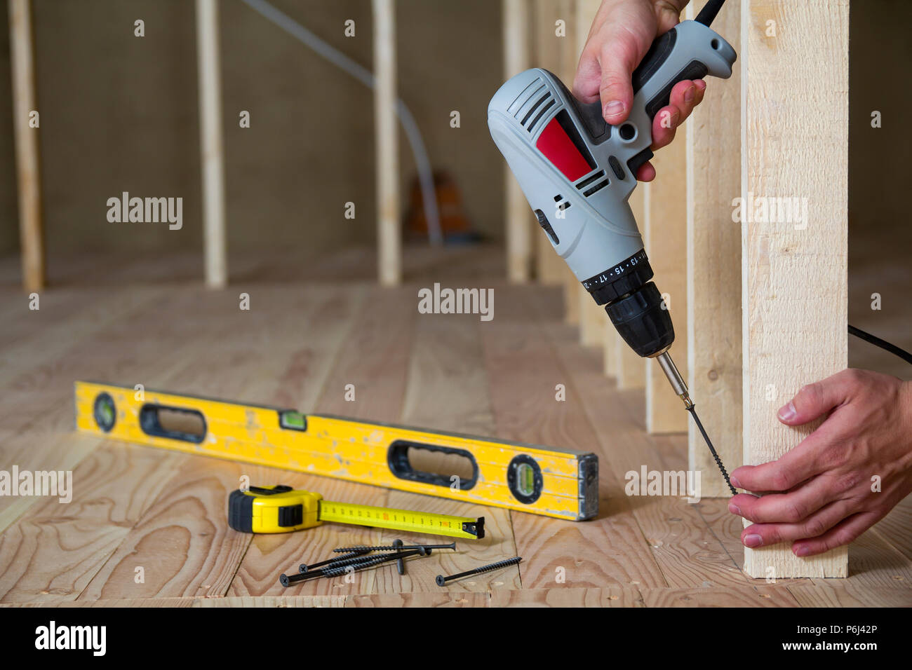 Close-up of worker's hands with screwdriver on background of ...