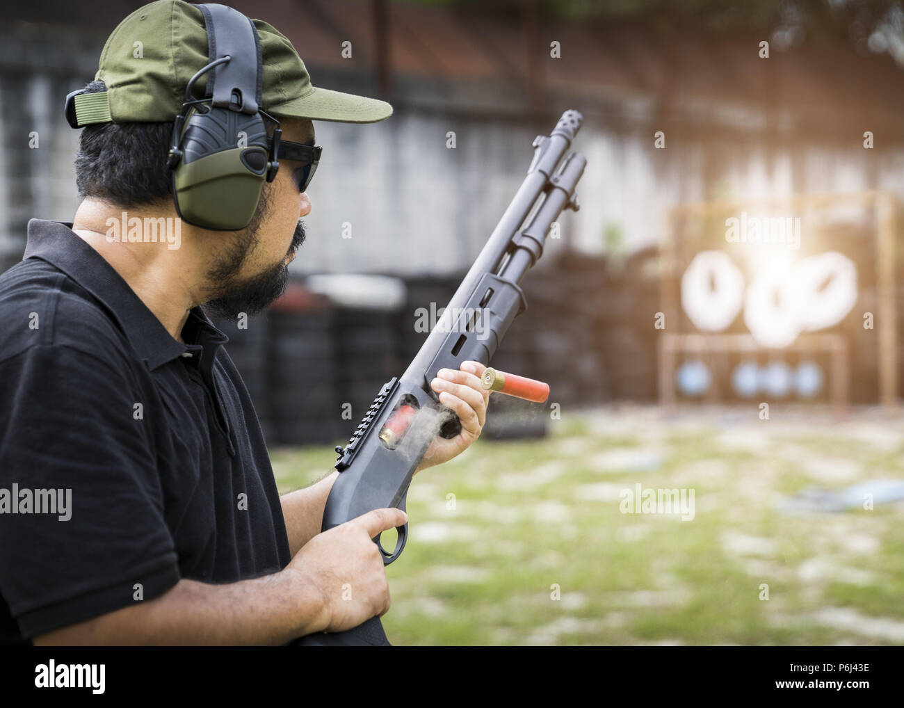 View of a man with a shotgun reload the cartridge Stock Photo - Alamy