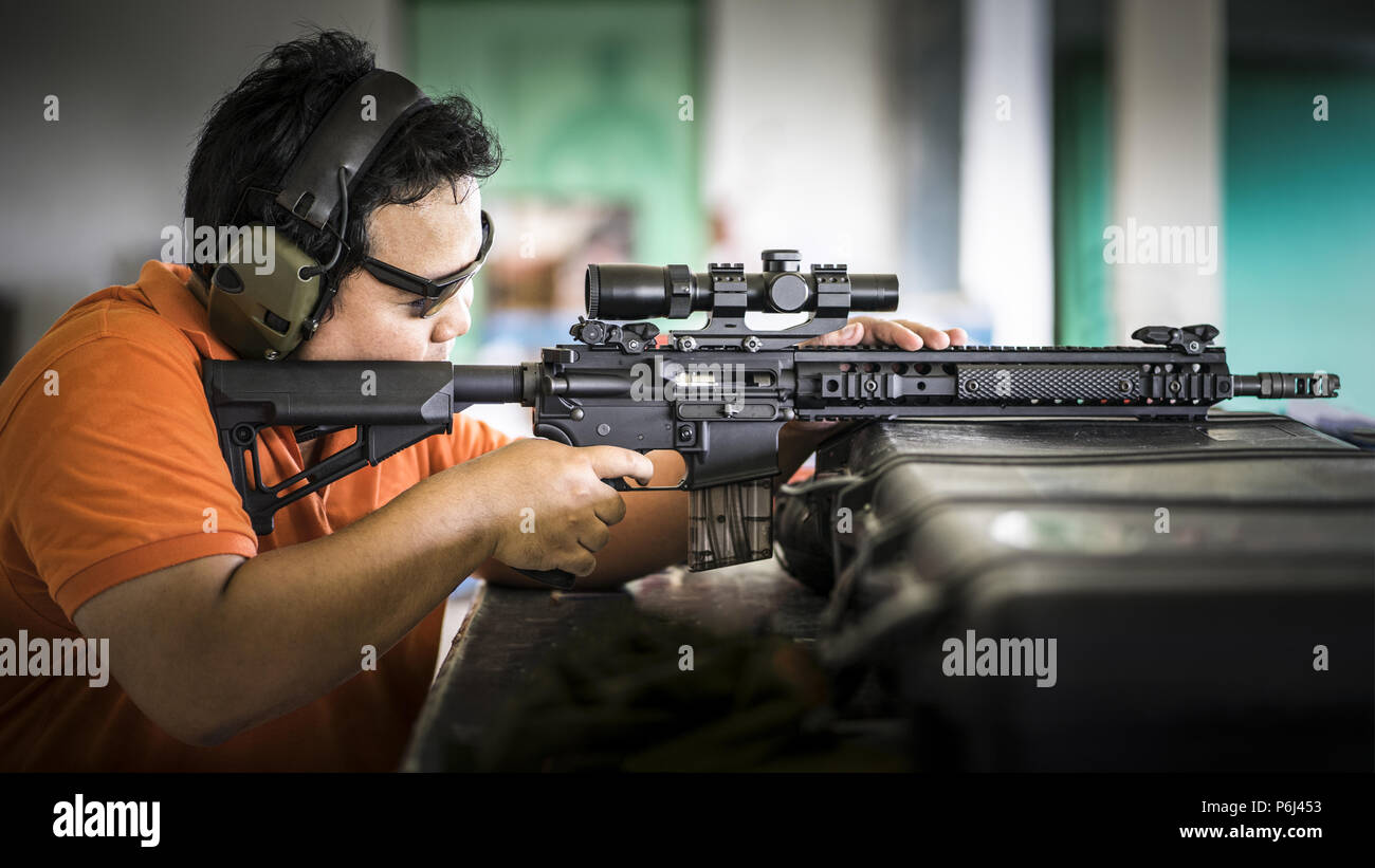 Man shooting on shooting range, selective focus Stock Photo - Alamy