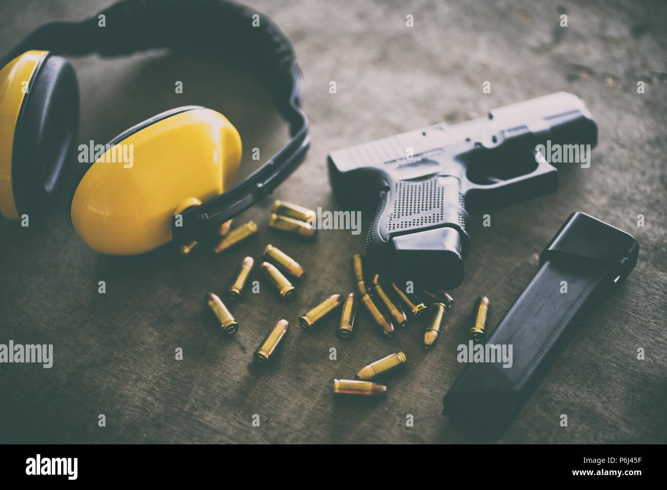 Gun with ammunition on wooden background Stock Photo - Alamy
