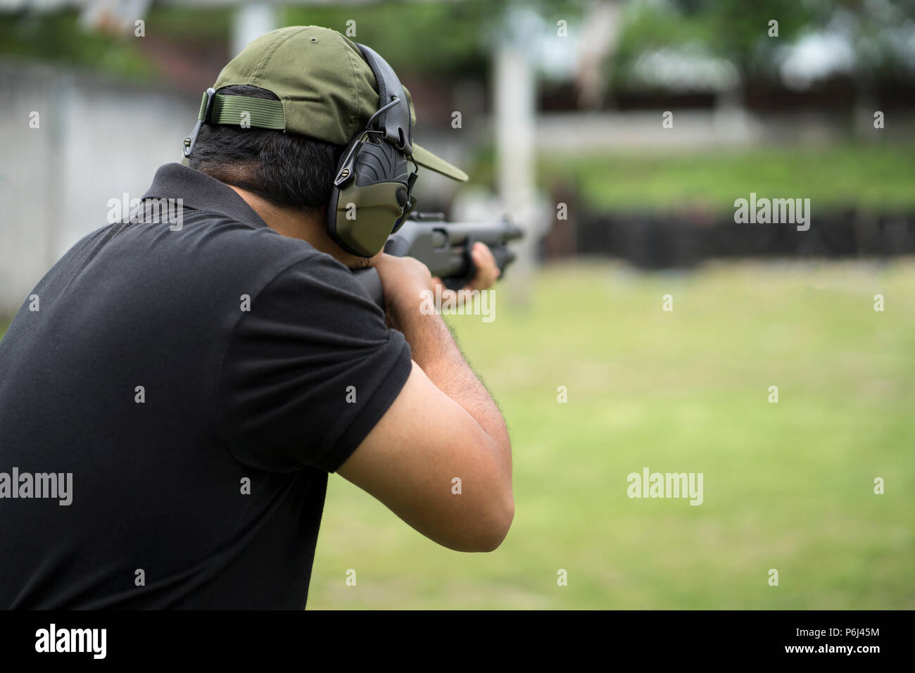 Man shooting on an outdoor shooting range, selective focus Stock Photo ...