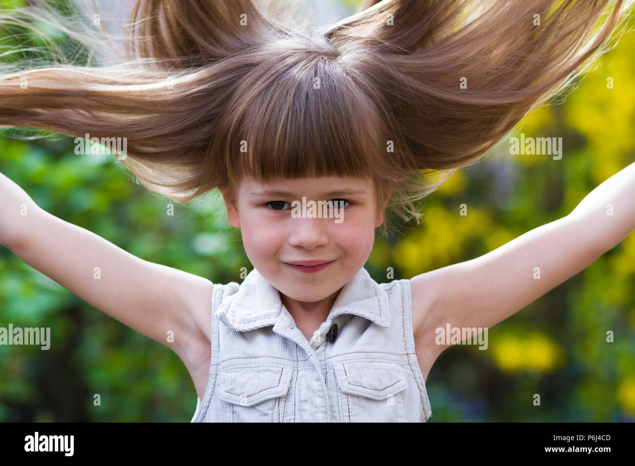Portrait of a pretty little long-haired blond preschool girl in ...