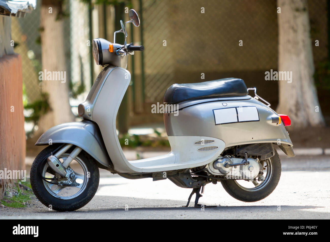 New white shiny motorbike scooter with two mirrors and manual brake ...