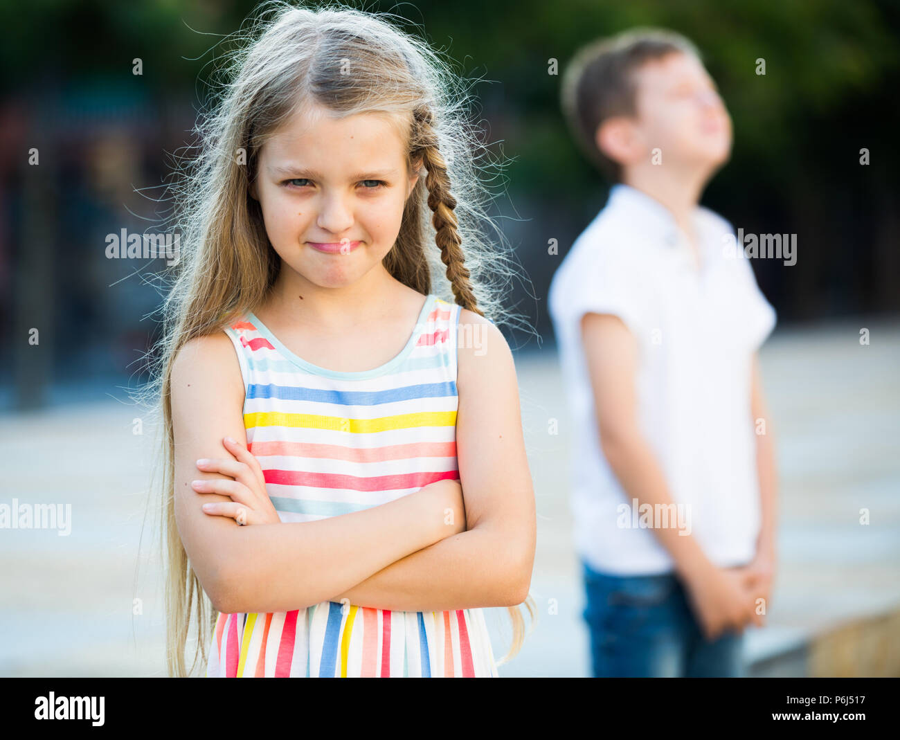 sad girl in preschool age having problem with friend outdoors in park ...