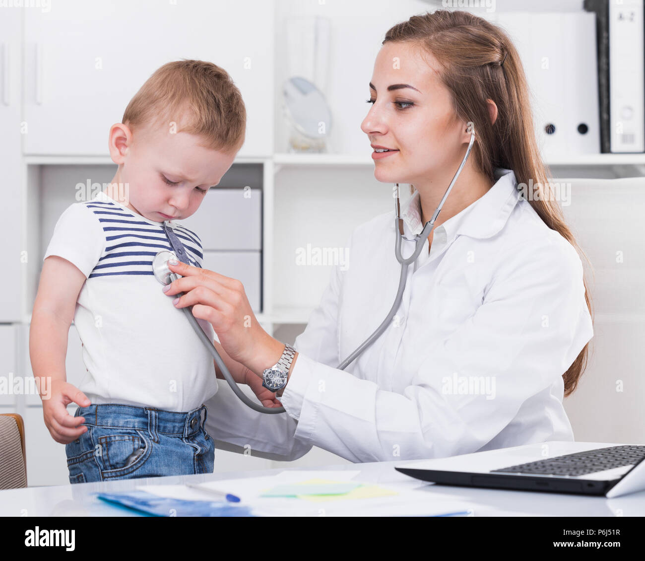 Doctor is listening child with a stethoscope in clinic Stock Photo - Alamy
