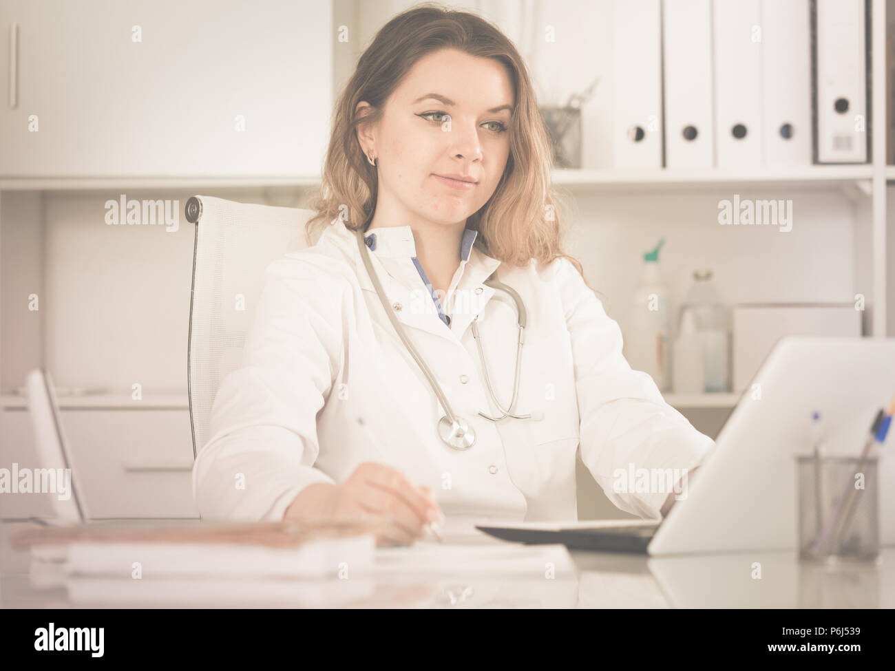 Young nurse filling documents hi-res stock photography and images - Alamy