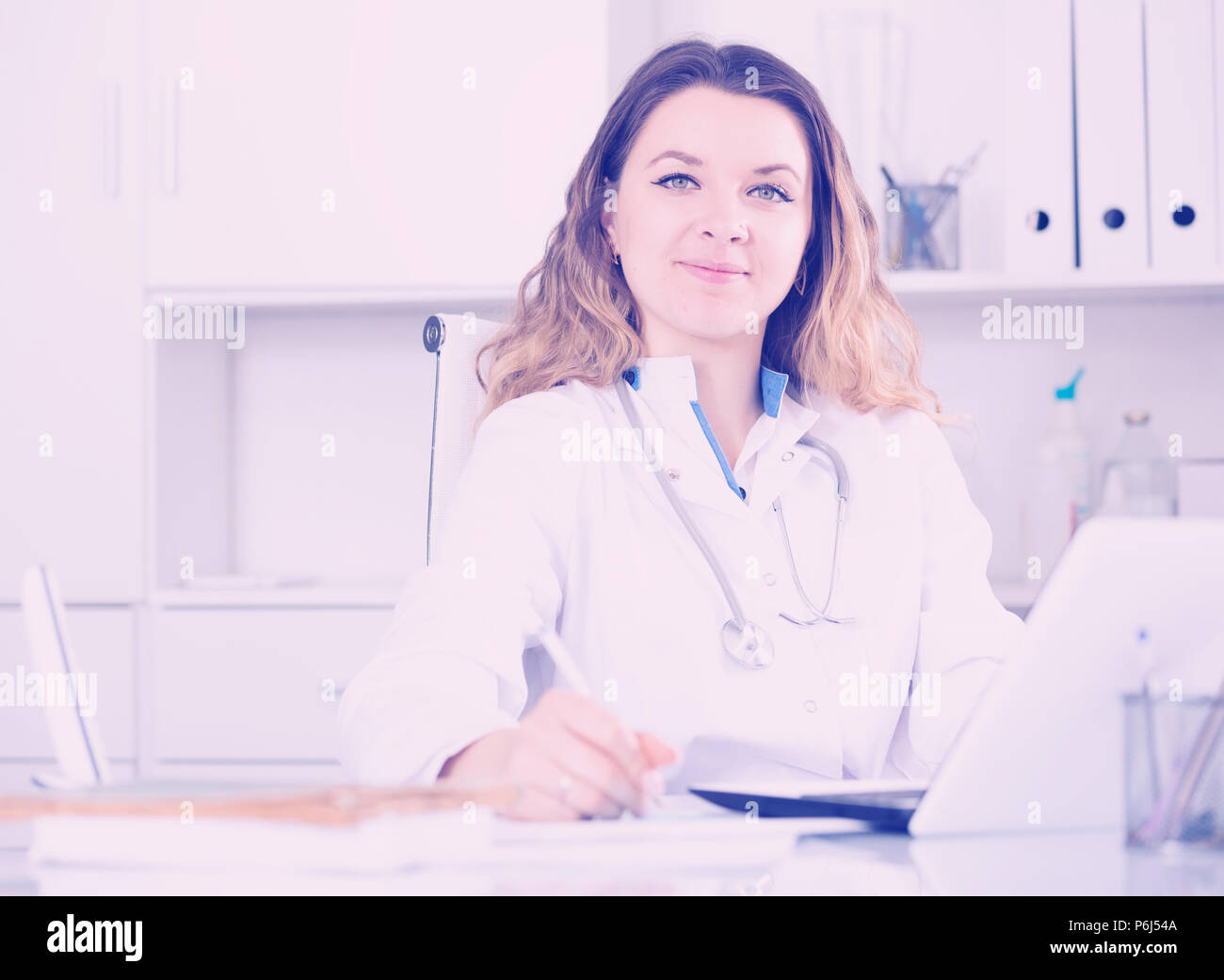 Young nurse filling documents hi-res stock photography and images - Alamy