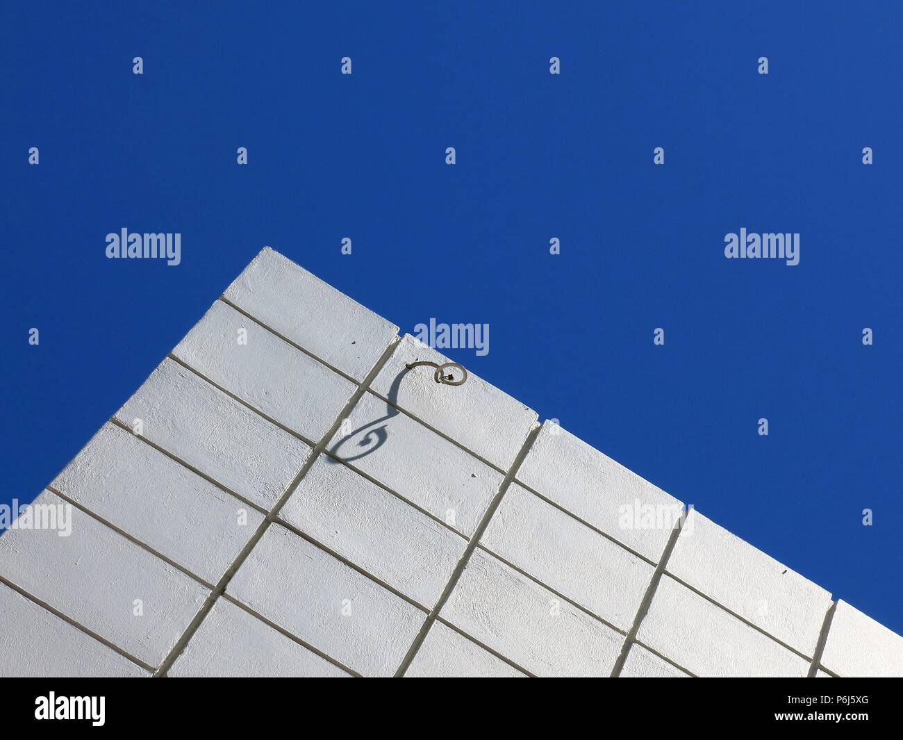 Shadow of a cable on a patterned wall of a building (minimal Stock ...