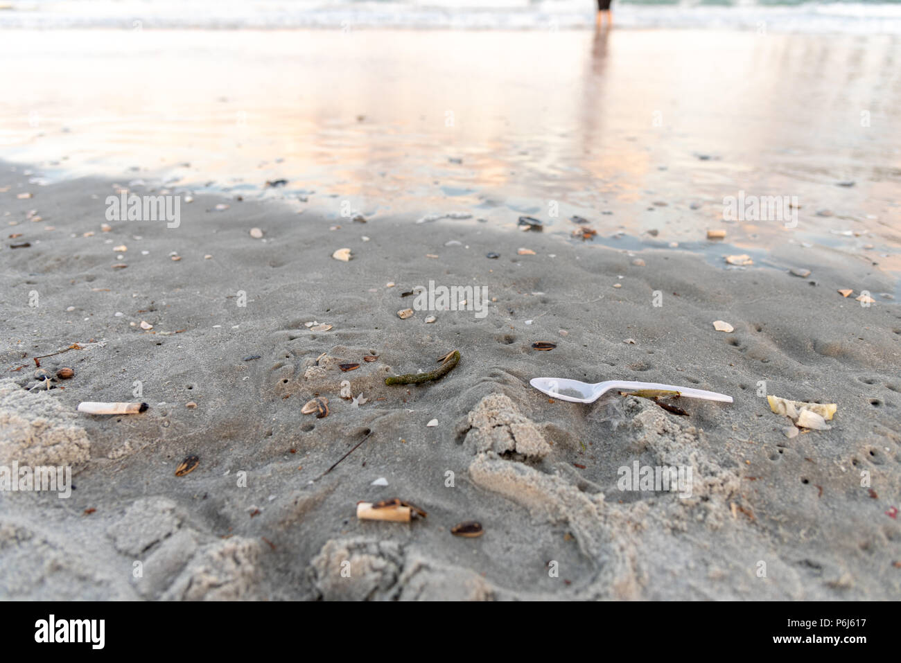 Beach pollution plastic spoon cigarettes and other garbage Stock Photo ...