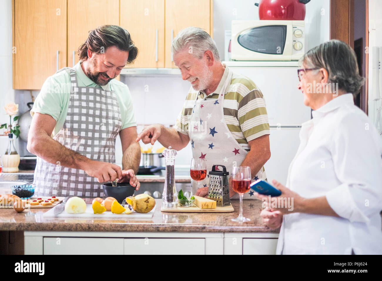 caucasian family three man people cook together lokking the how to do ...