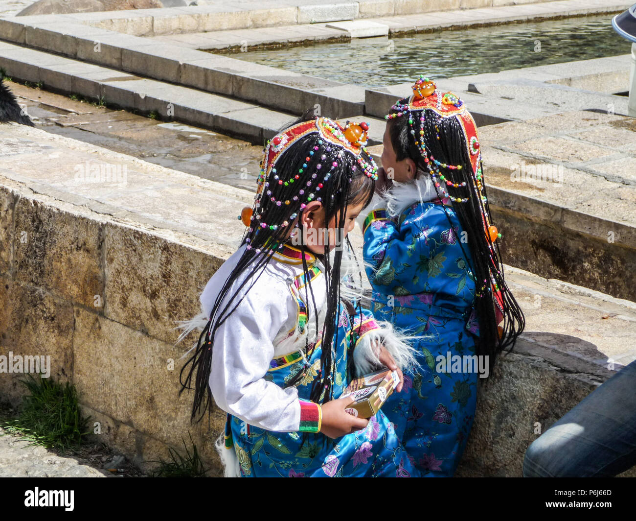 Two young girls of the Naxi minority in Zhongdian old town, Shangri-La ...