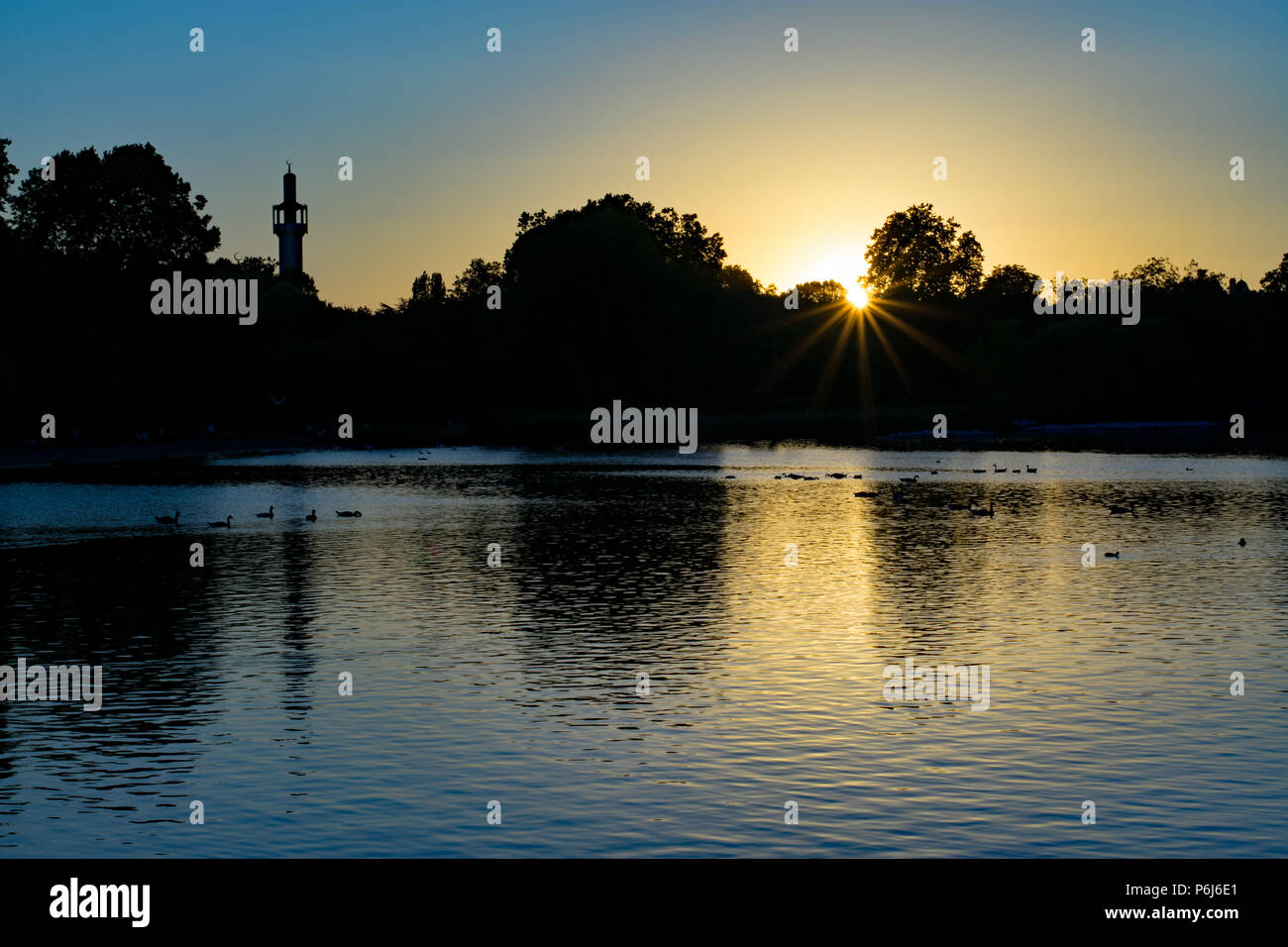 Lakeside reflections at sunset Stock Photo - Alamy