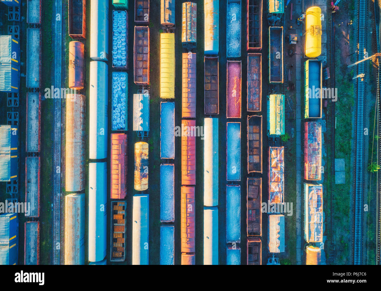 Aerial view of cargo trains. Railway wagons with goods on railroad. Top ...