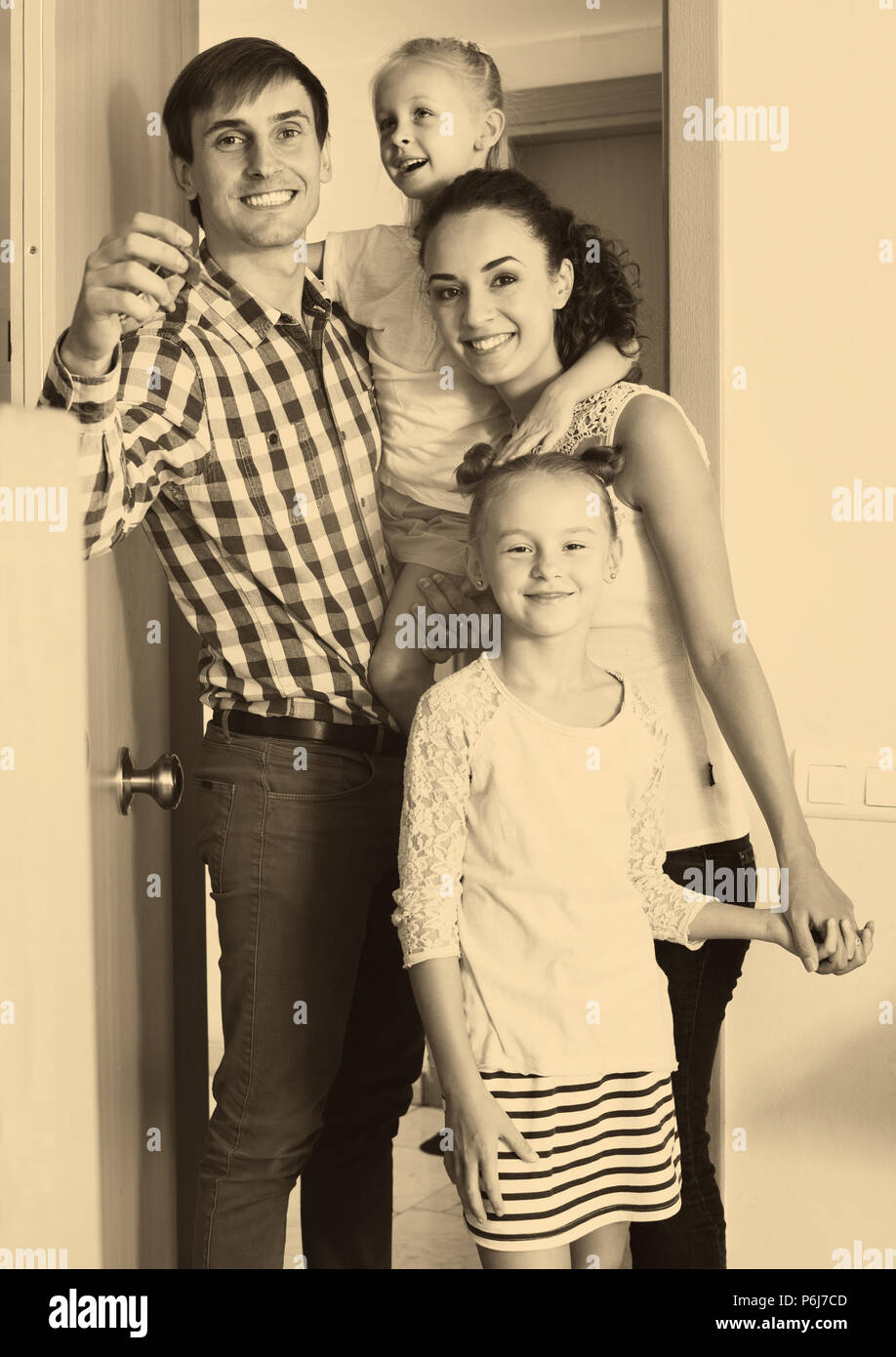 european parents with kids standing at doorway of rented property Stock ...